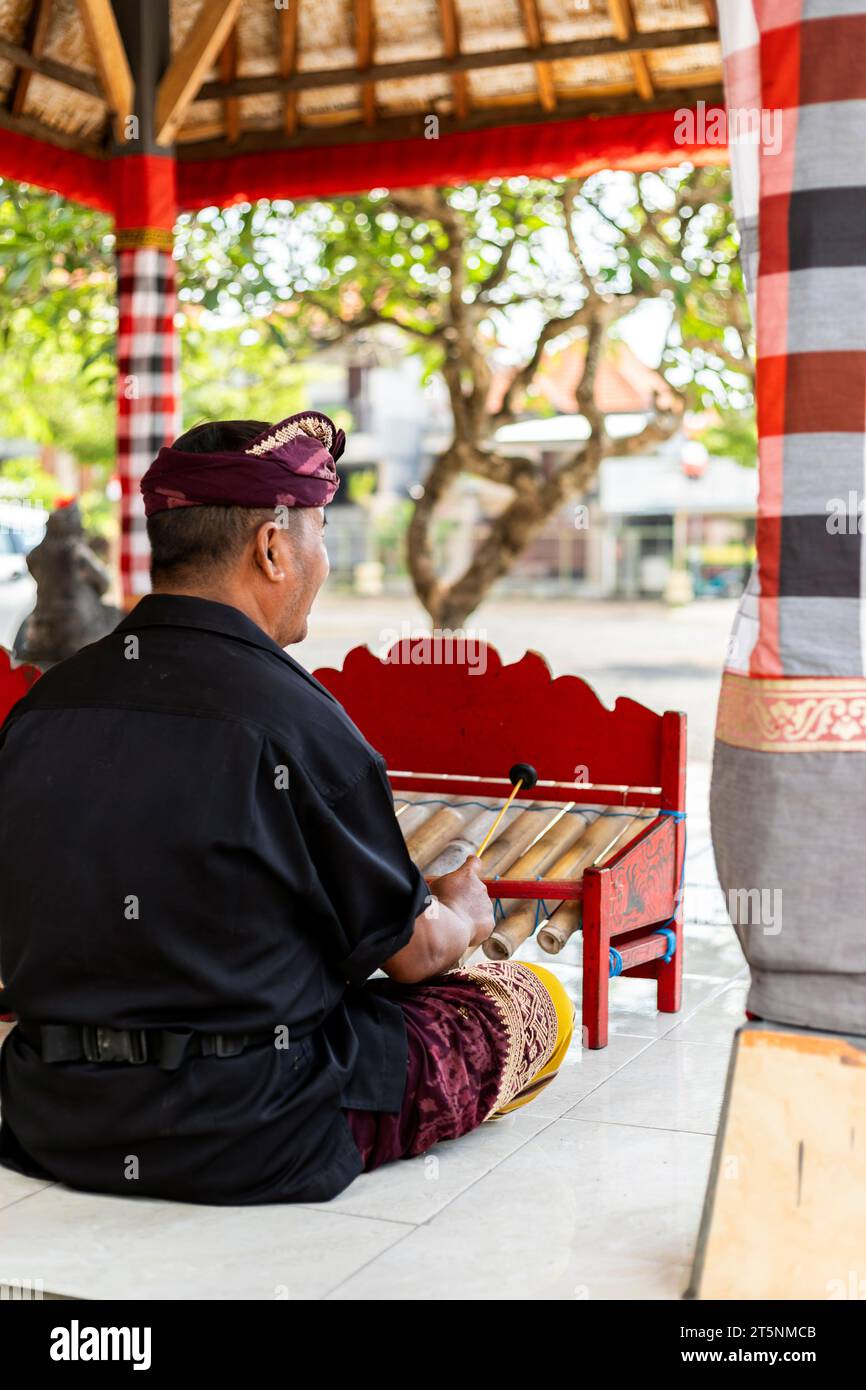 Balinese man playing an instrument Stock Photo - Alamy