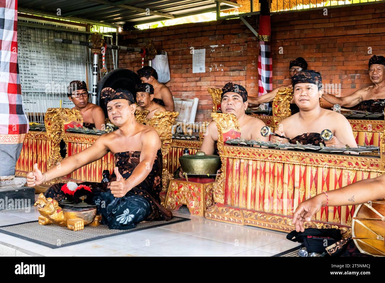 Balinese men playing instruments during a traditional morning dance ...