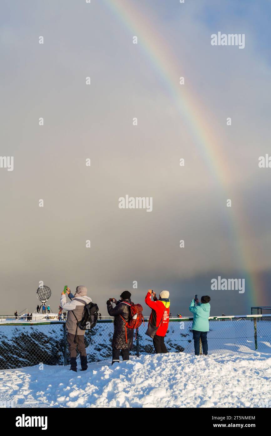 visitors photograph the stunning rainbow over the Globe monument ...