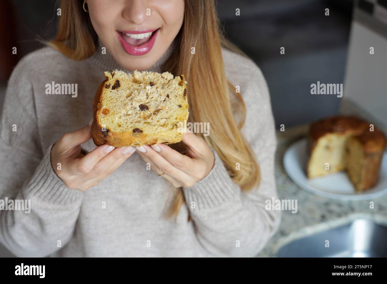 Unrecognizable girl eating a slice of Panettone traditional Christmas ...