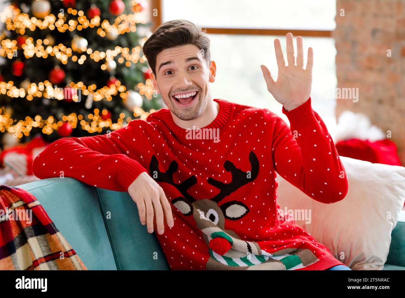 Portrait of cheerful nice person sit comfy sofa arm palm waving hi ...