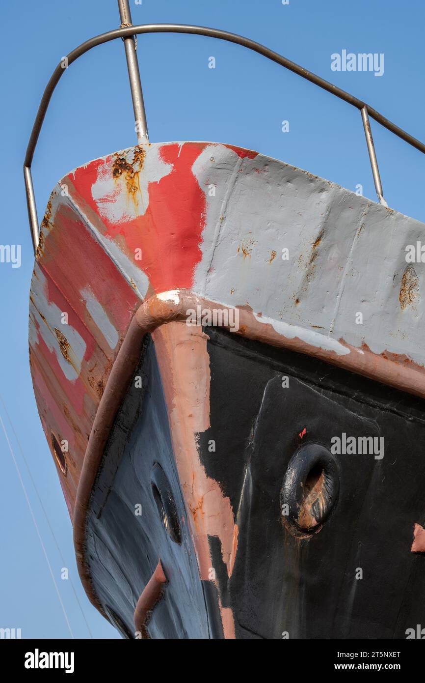 rusty old hull or bows of a shipwrecked fishing bot in the harbour on ...