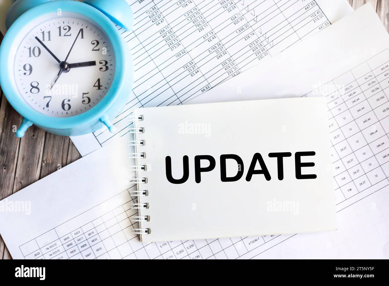 Notepad with update text. updating the marketing plan on documents ...