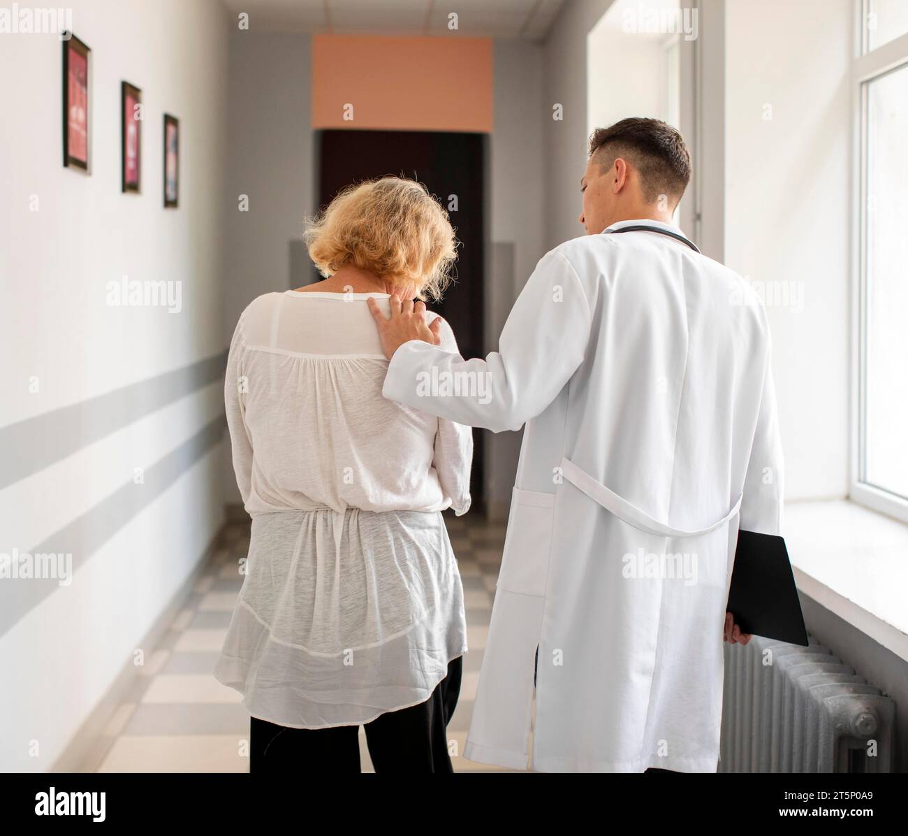 Back view senior patient doctor walking Stock Photo - Alamy