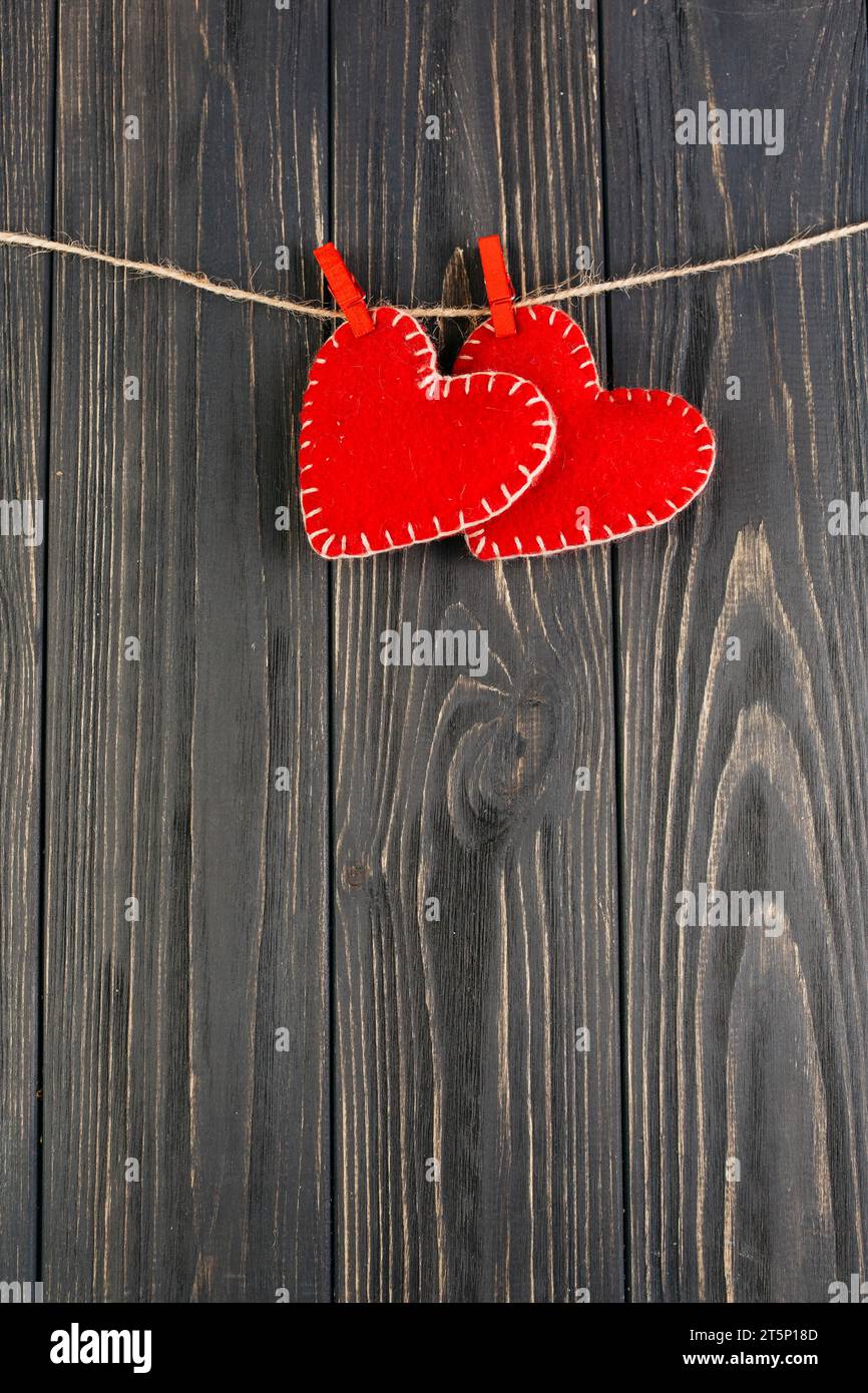 Red heart shaped felt toys hanging string Stock Photo - Alamy