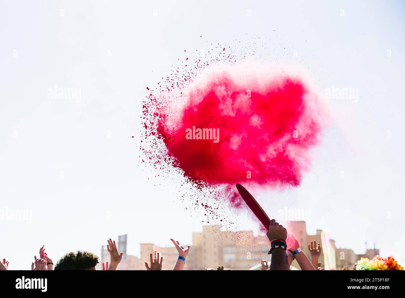 Red holi color explosion crowd Stock Photo - Alamy