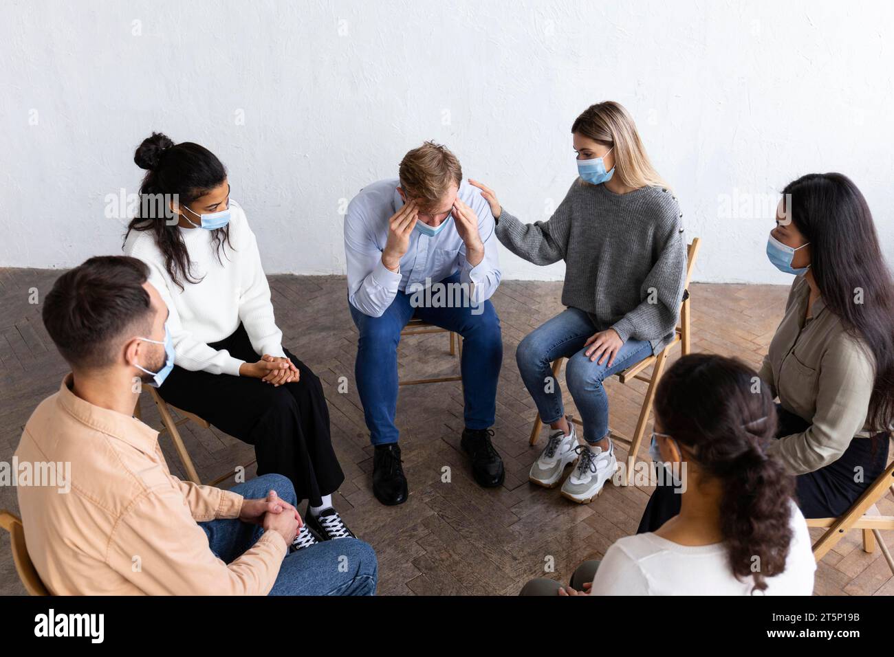 People with medical masks group therapy session Stock Photo - Alamy