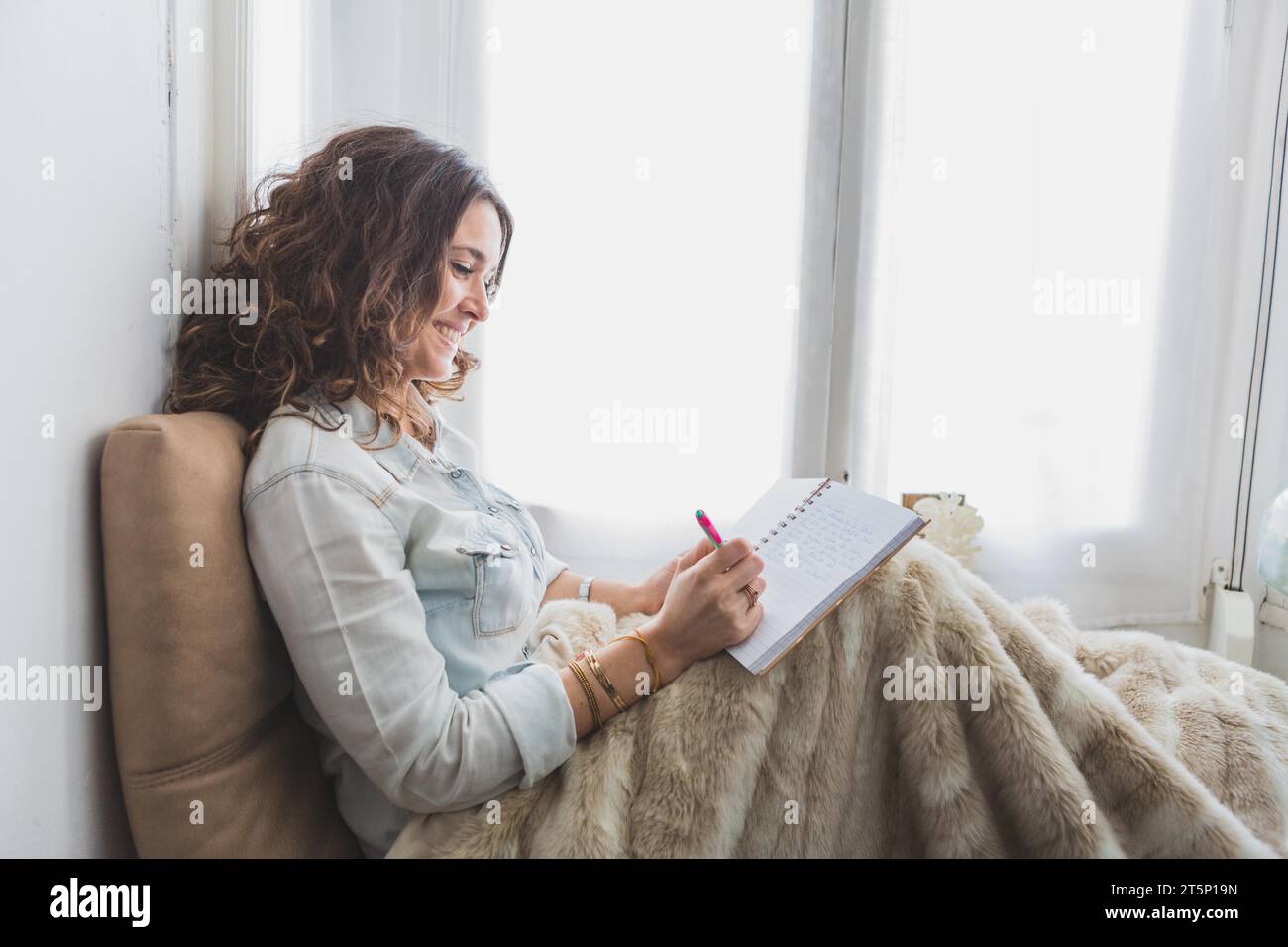 Woman writing book sofa hi-res stock photography and images - Alamy