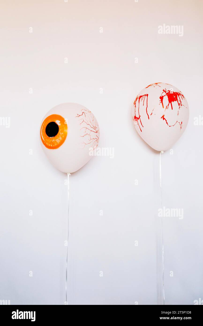 Scary balloons with blood white wall Stock Photo - Alamy