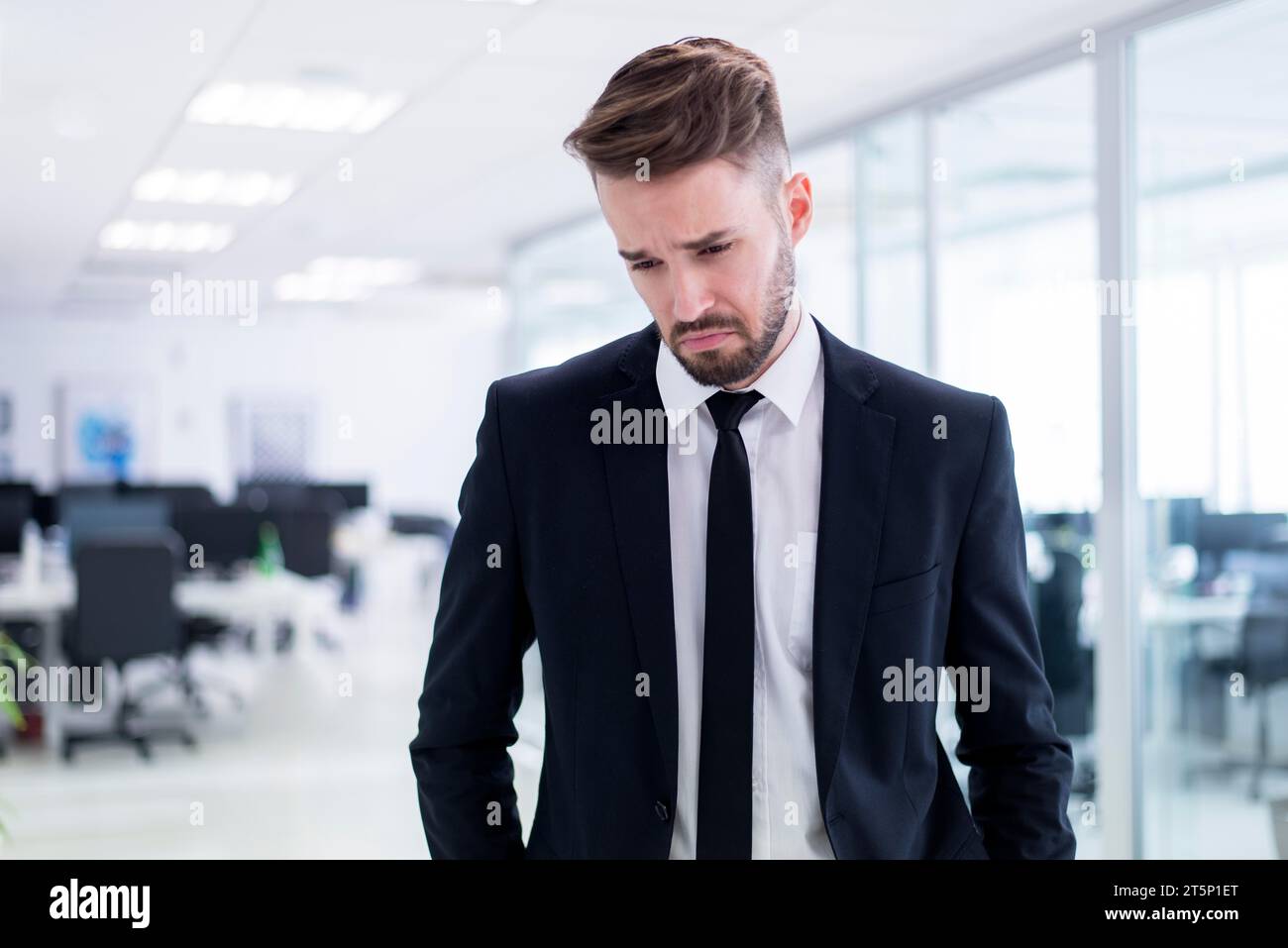 Sad man looking down Stock Photo - Alamy