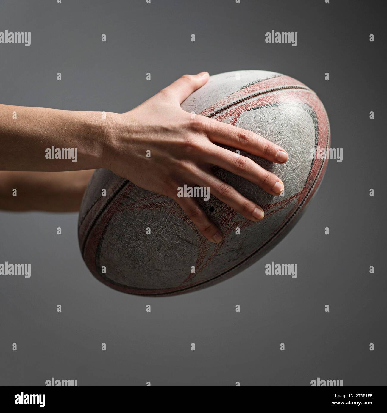 Side view female rugby player s hand holding ball Stock Photo - Alamy