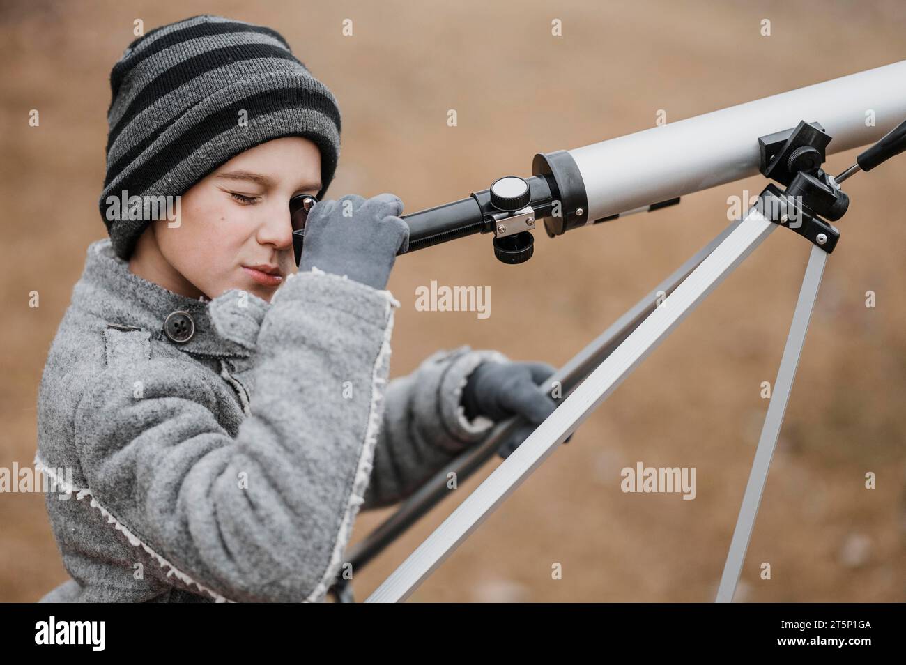 Side view boy using telescope Stock Photo - Alamy