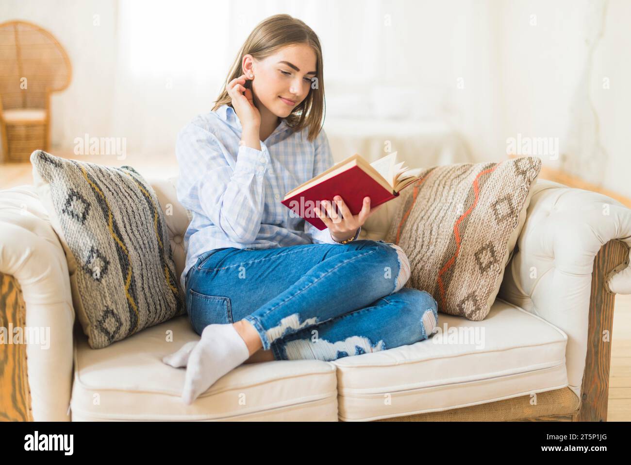 Smiling beautiful woman reading story book Stock Photo - Alamy