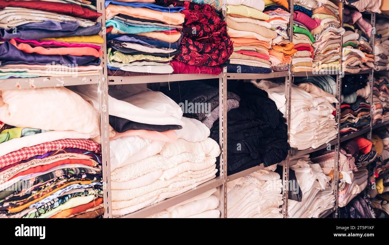 Stacked colorful fabrics shelf Stock Photo - Alamy