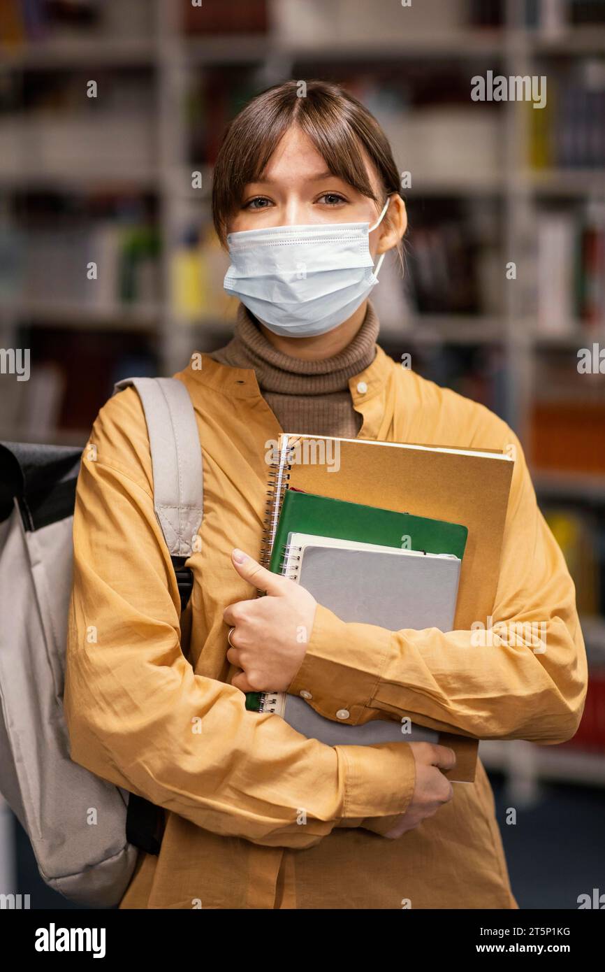 Student wearing medical masks library Stock Photo - Alamy