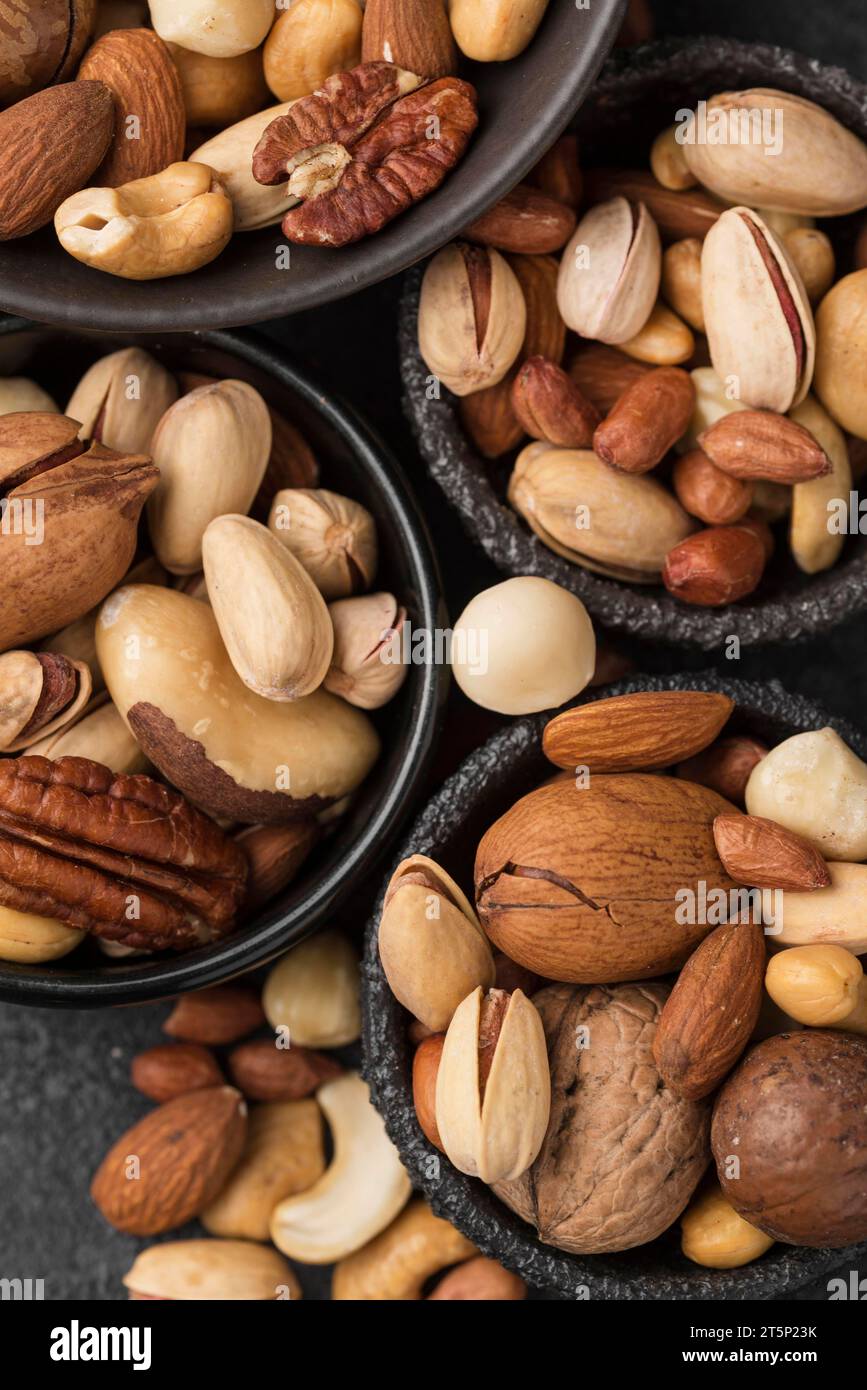 Top view various bowls filled with nuts Stock Photo - Alamy