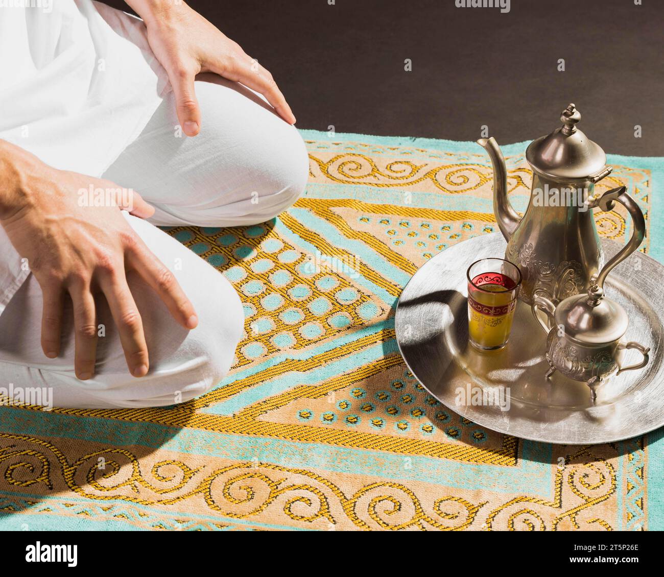 Traditional arabic hot tea man sitting Stock Photo - Alamy