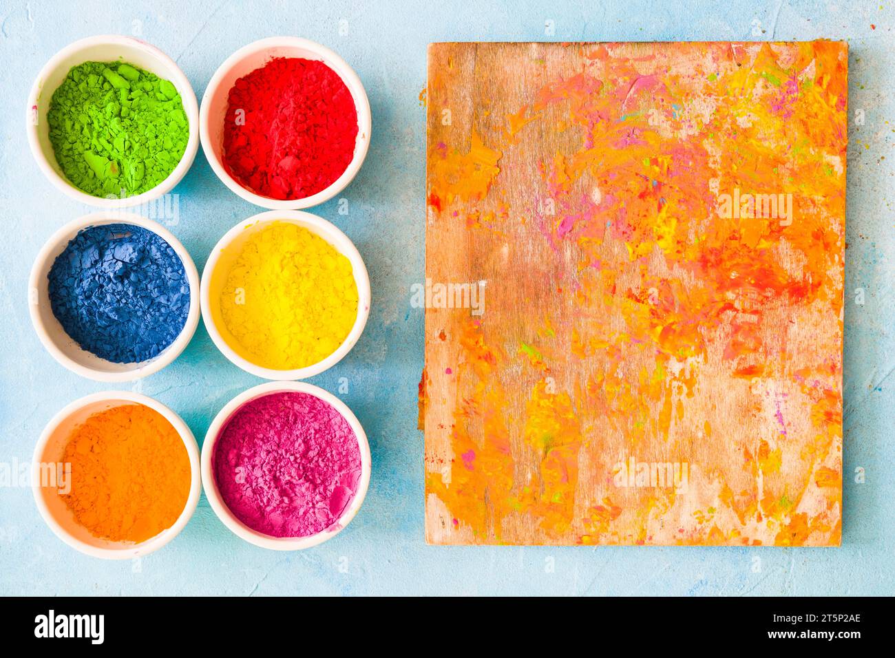 Wooden board mess with holi color powder painted background Stock Photo ...