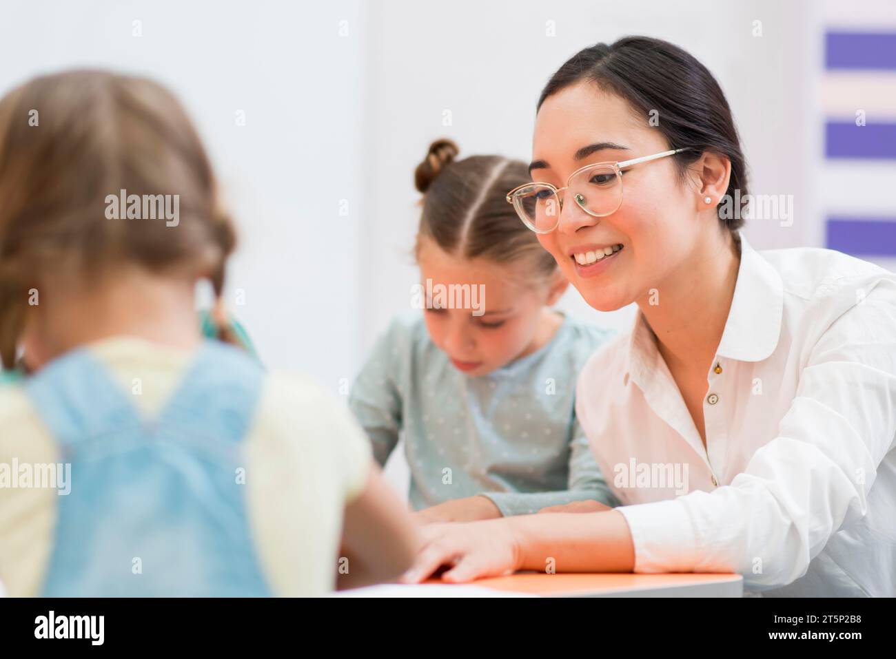 Woman talking with her students during class Stock Photo - Alamy