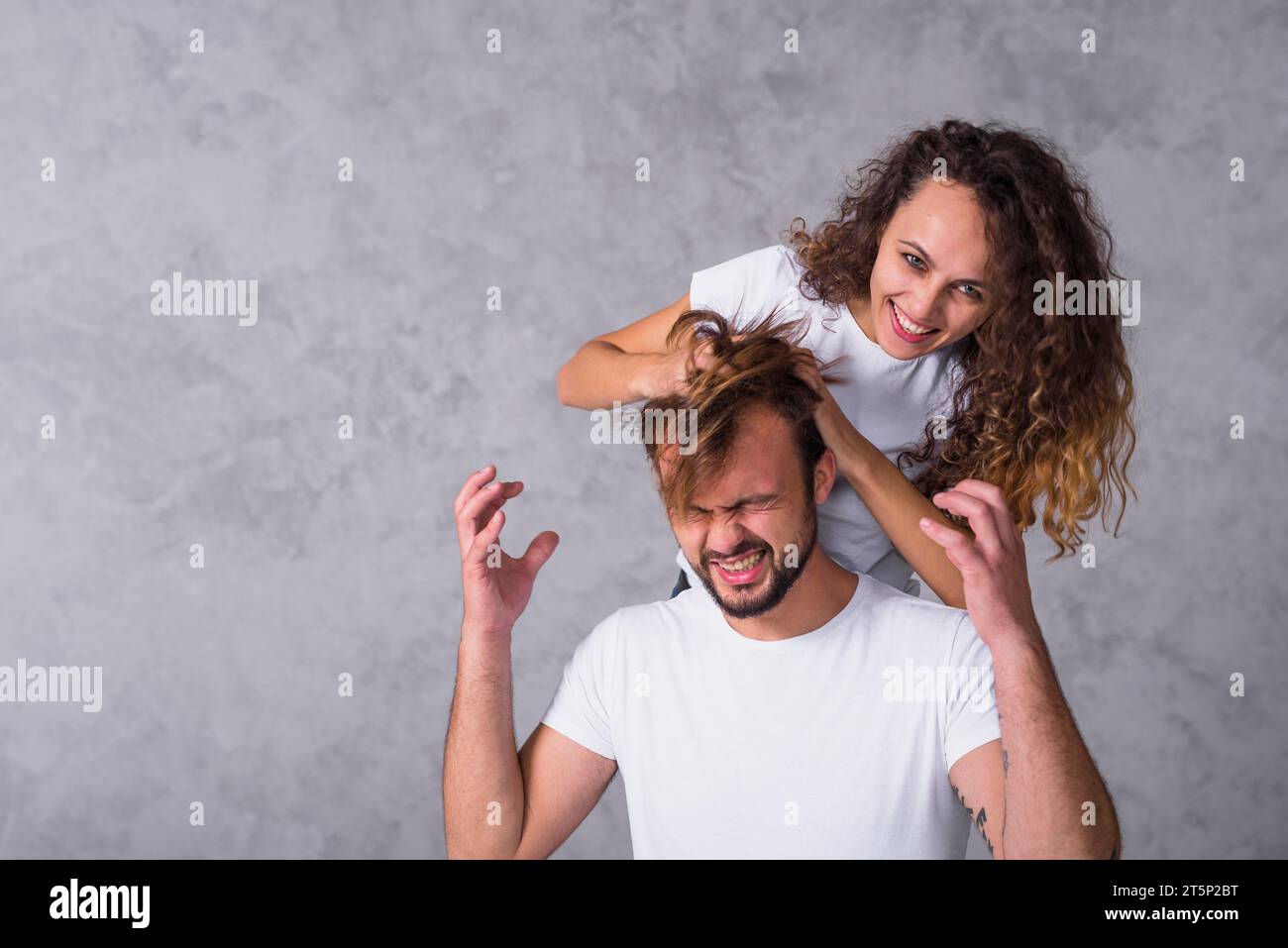 Woman running fingers through man hair Stock Photo - Alamy