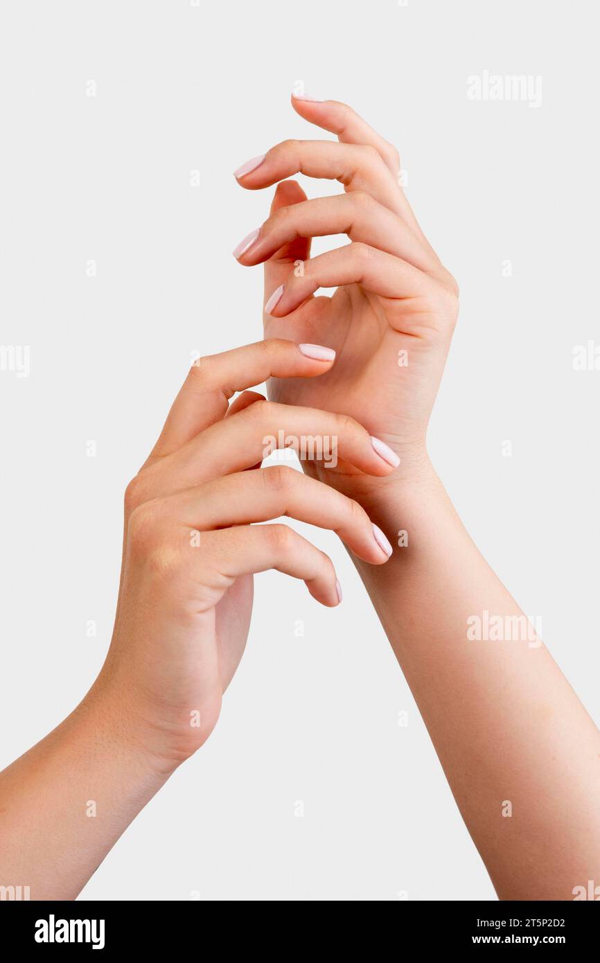 Woman showing her manicure white background Stock Photo - Alamy