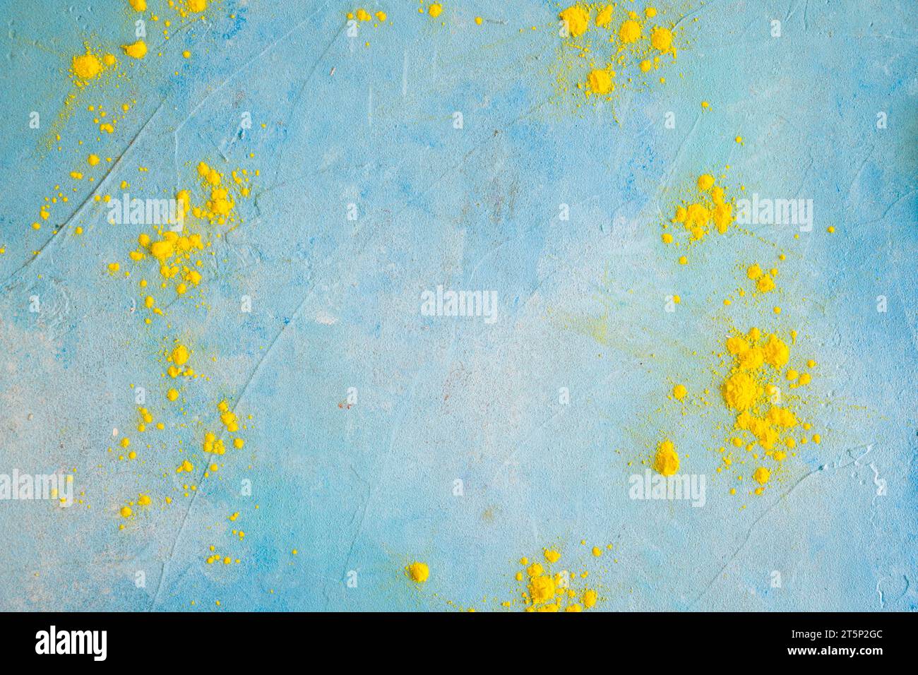 Yellow color powder painted blue wall Stock Photo - Alamy