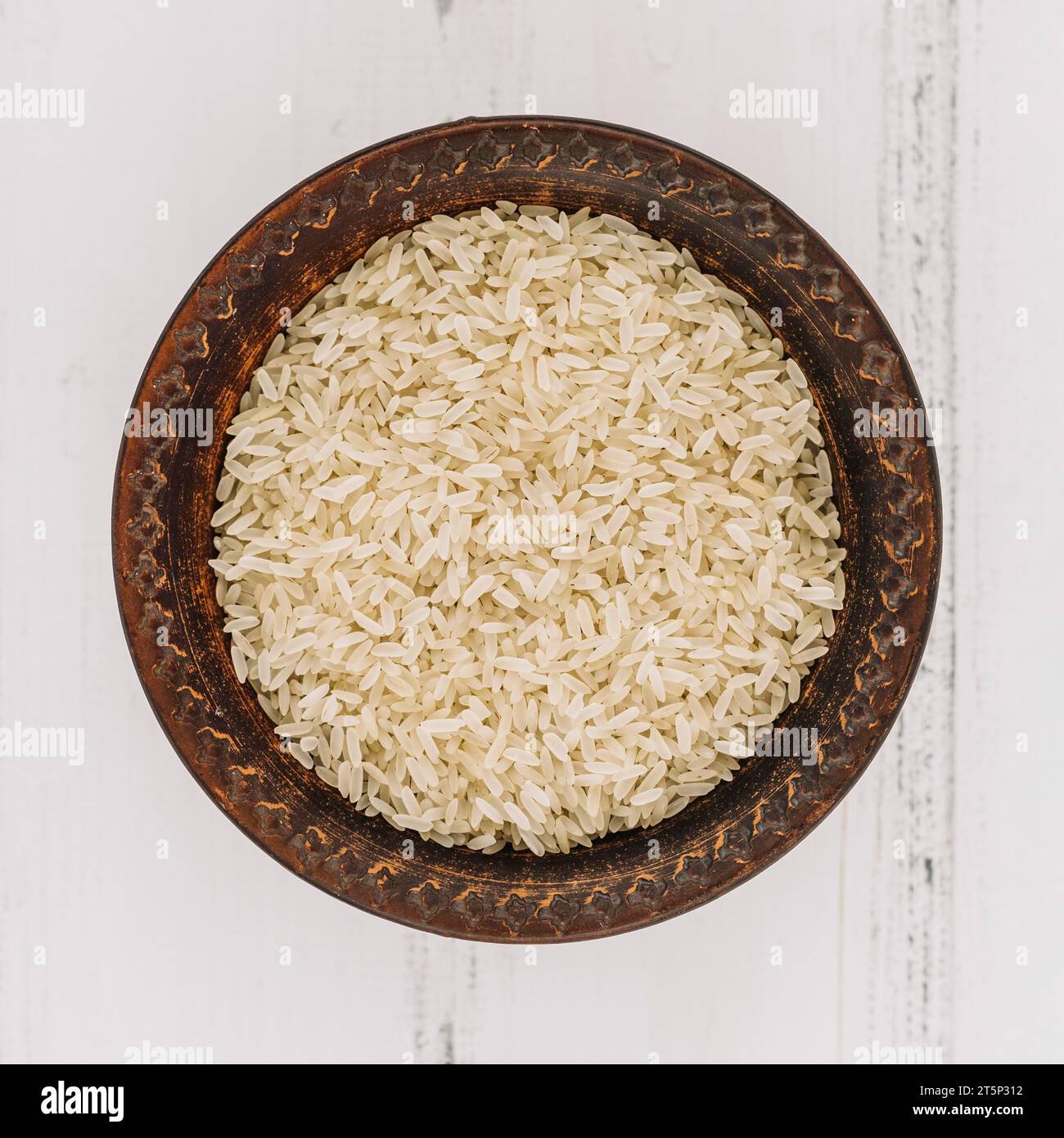 Bowl with uncooked rice Stock Photo - Alamy