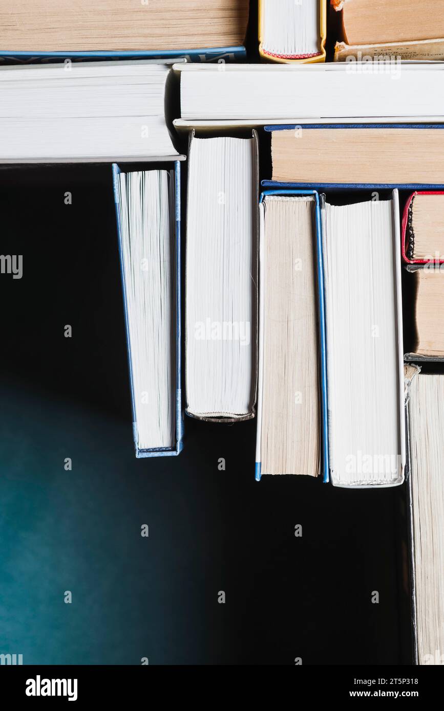 Books stacked blue background Stock Photo - Alamy
