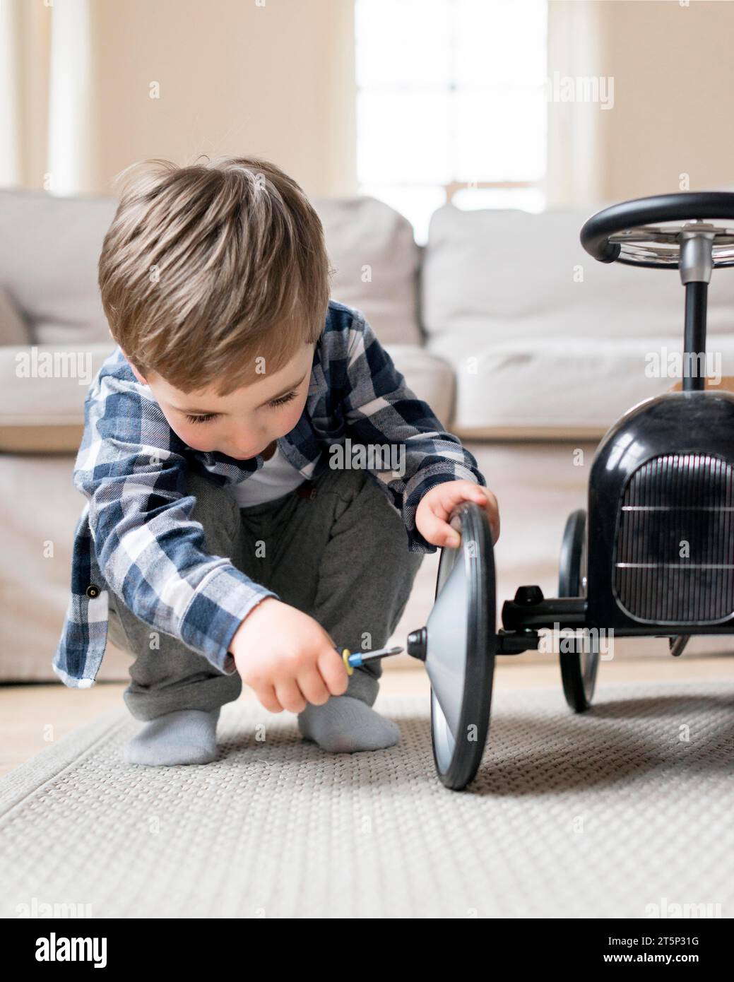 Boy fixing his wheels from race car Stock Photo - Alamy