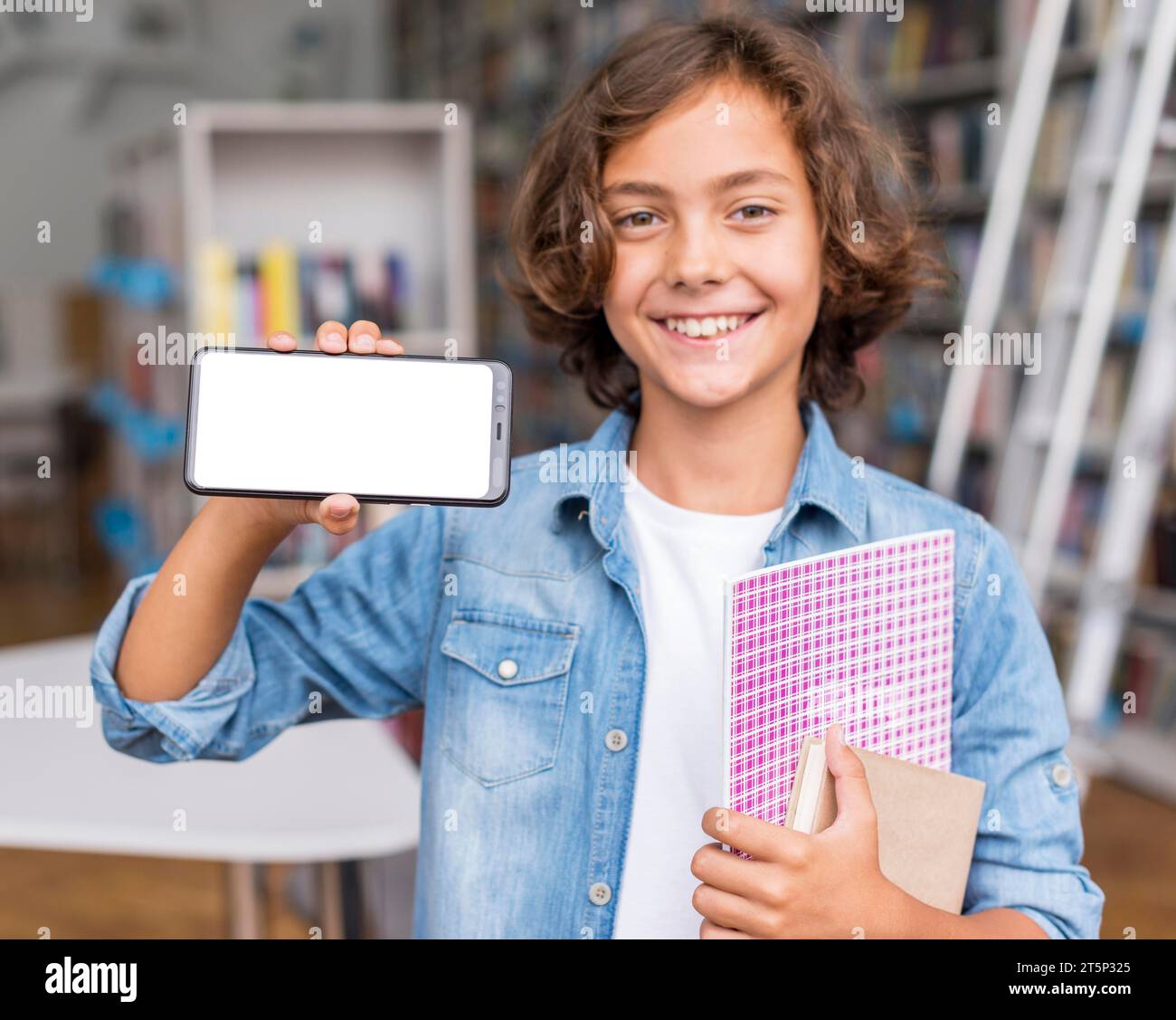 Boy holding empty screen phone library Stock Photo - Alamy