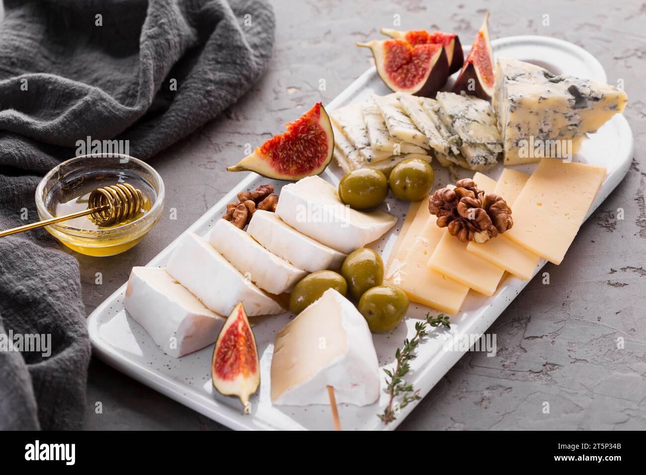 Cheese assortment platter with fig Stock Photo - Alamy