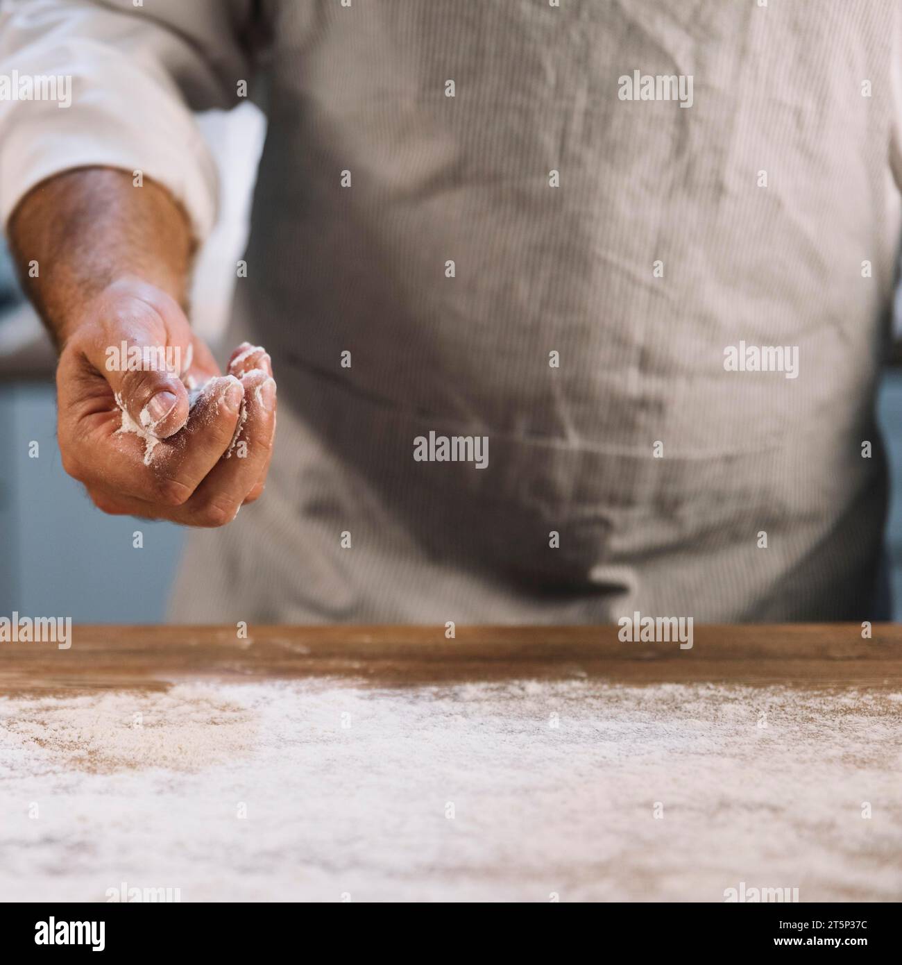 Close up baker dusted wooden table with wheat flour Stock Photo - Alamy
