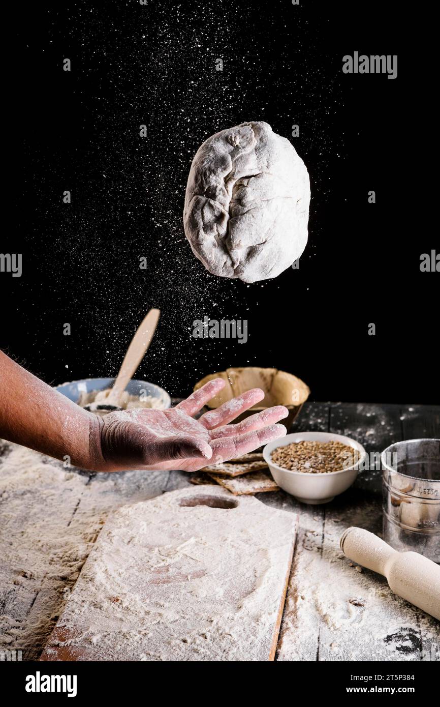 Close up man s hand throwing bread dough air Stock Photo - Alamy