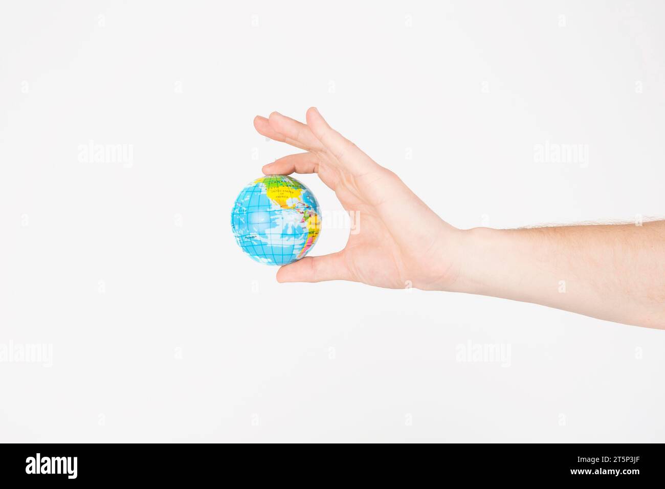 Crop hands holding little globe Stock Photo - Alamy
