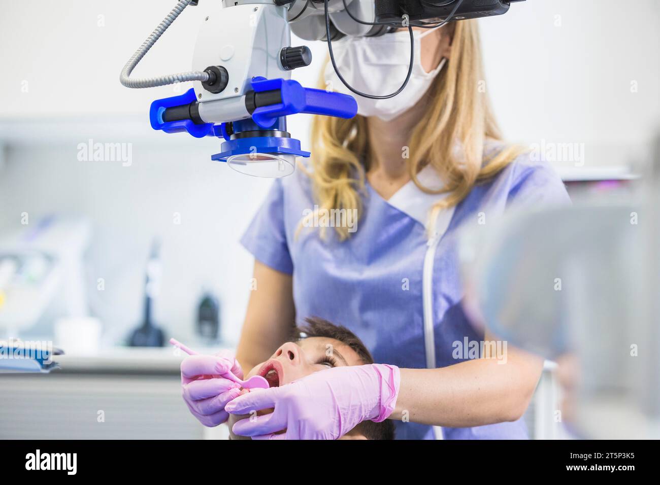 Dentist examining patient s teeth through microscope clinic Stock Photo ...