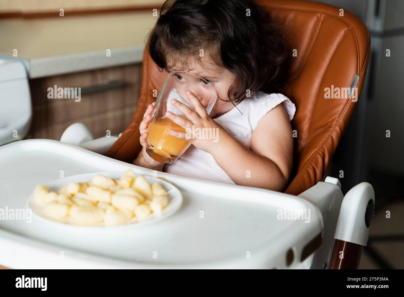 Cute young girl drinking juice Stock Photo - Alamy