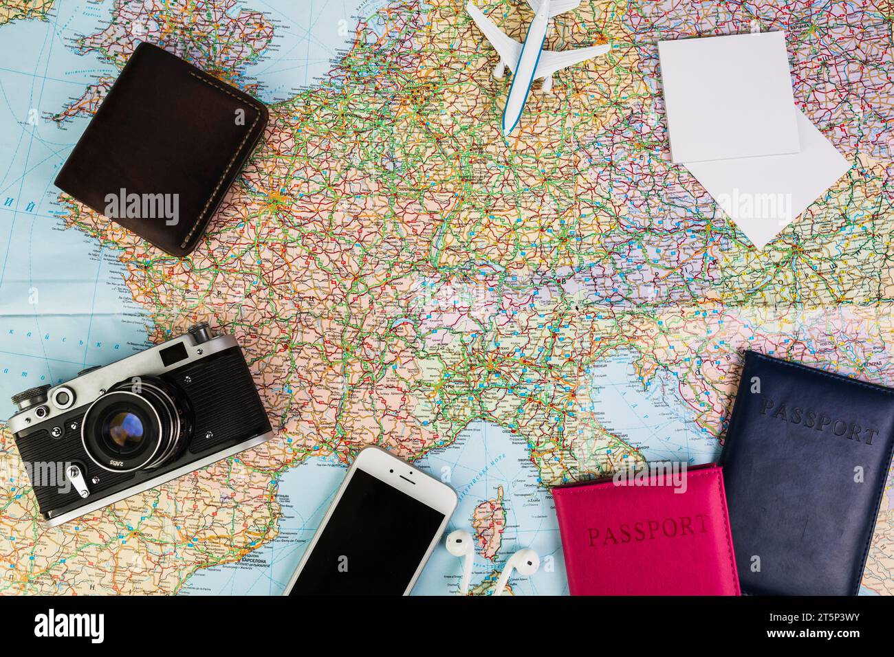 Electronic gadgets with passport wallet world map Stock Photo - Alamy