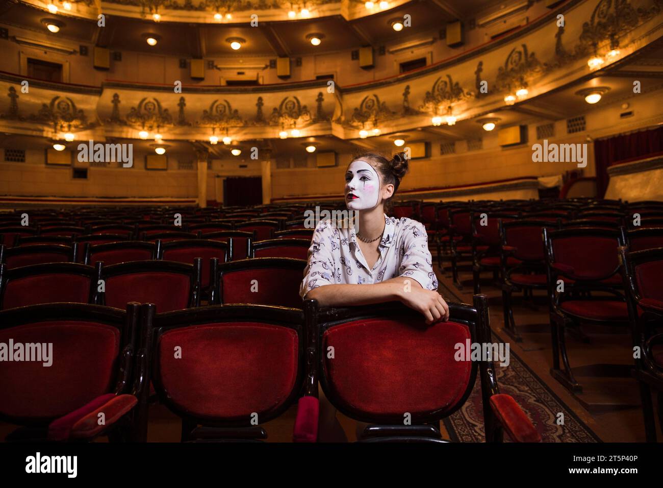 Female mime sitting chair Stock Photo - Alamy