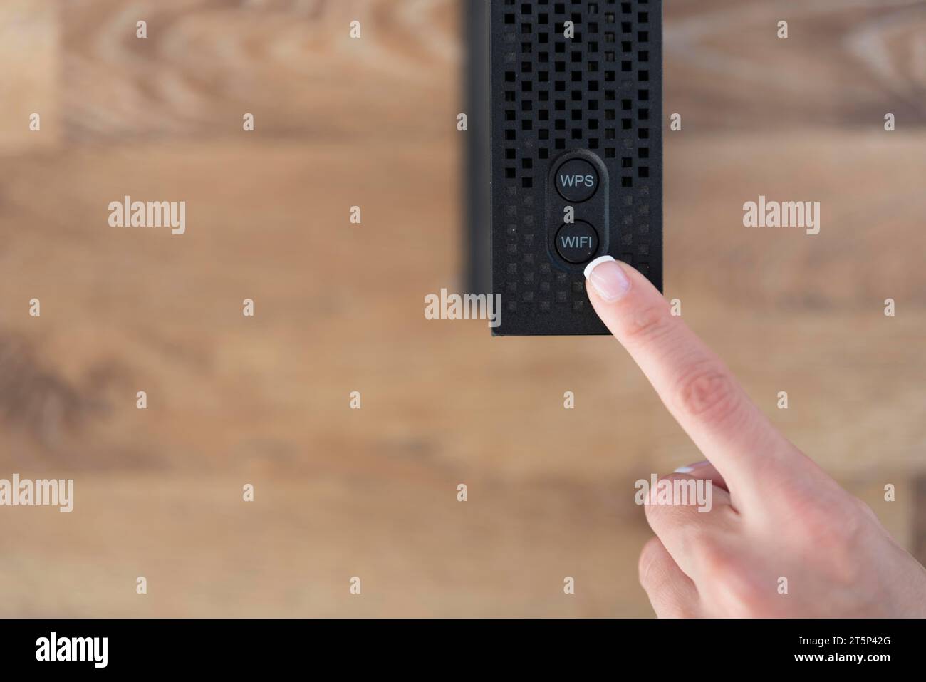 Finger near wifi button wifi router Stock Photo - Alamy