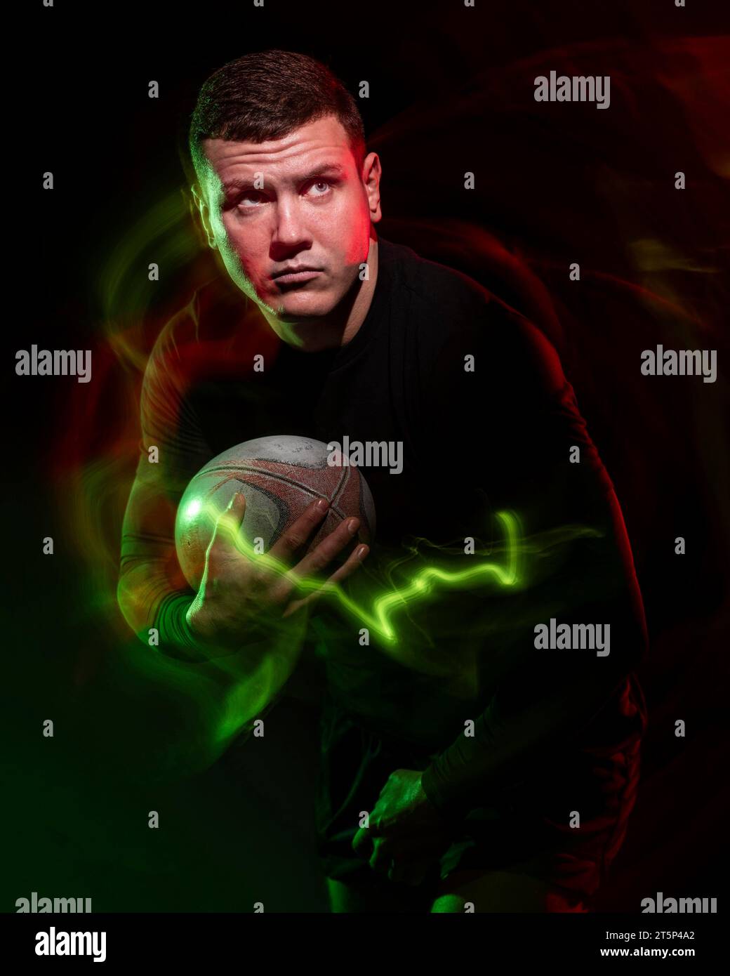 Front view male rugby player holding ball with color effect Stock Photo ...