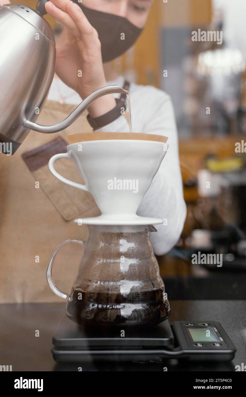 Front view female barista straining coffee Stock Photo - Alamy