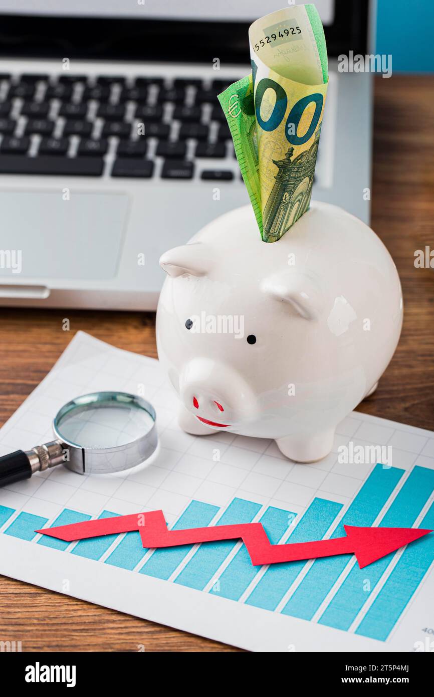 High angle office items with piggy bank growth chart Stock Photo - Alamy