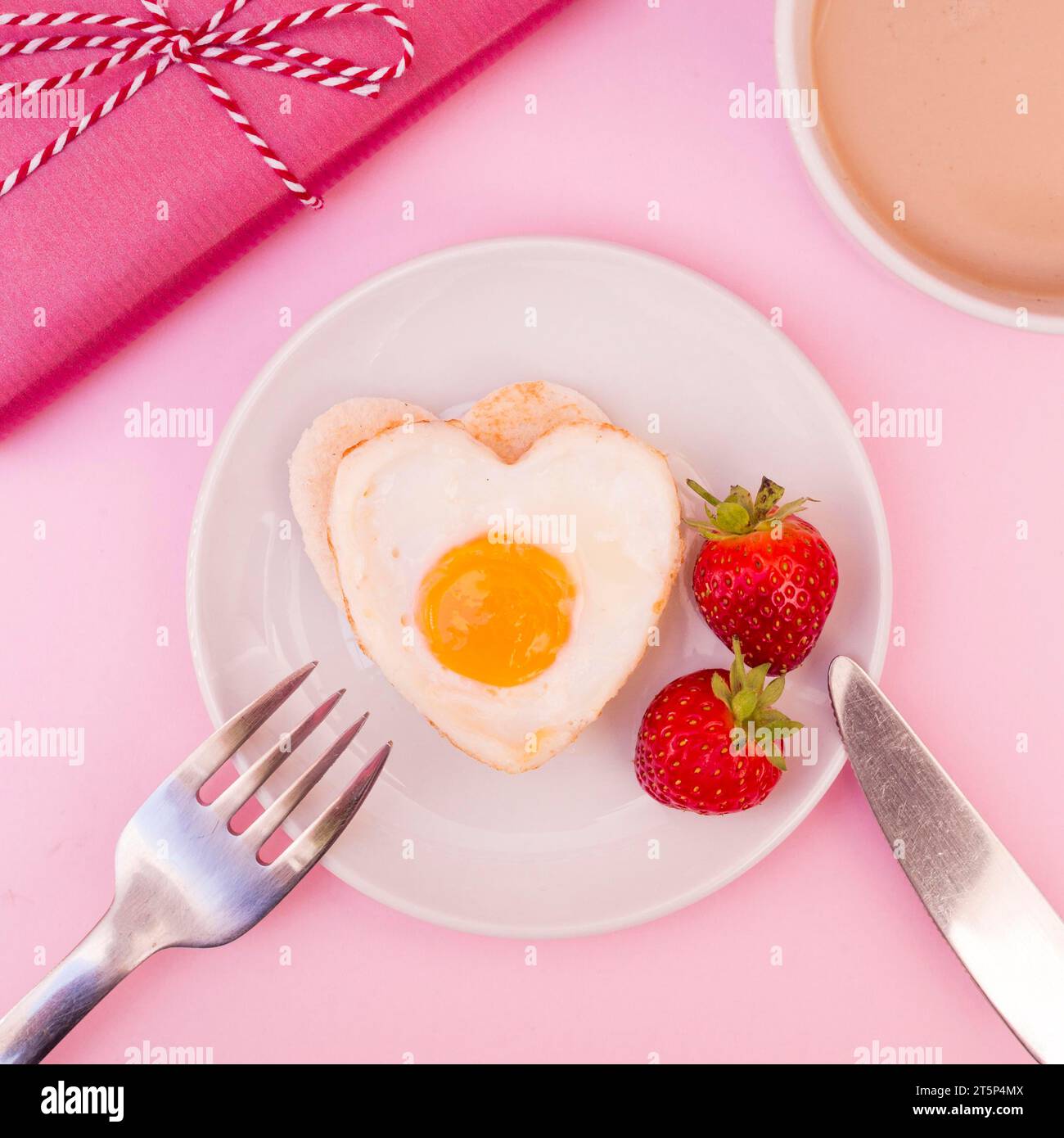 Heart shaped fried eggs Stock Photo - Alamy