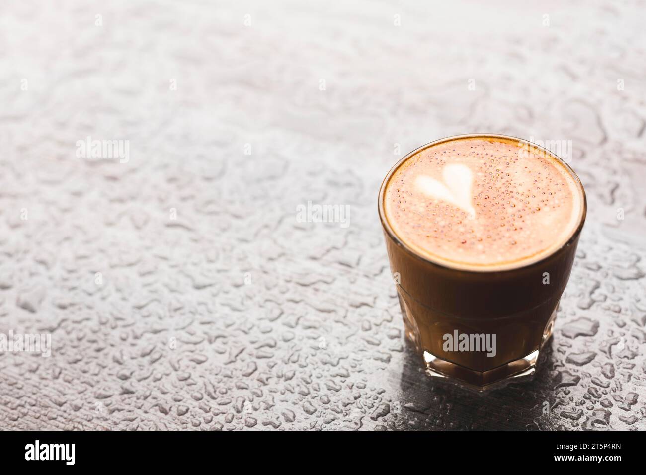 Hot latte with heart shape glass water drop surface Stock Photo - Alamy