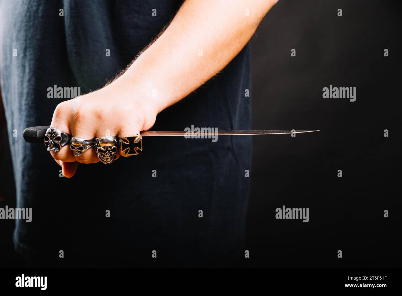 Male hand with sharp dagger Stock Photo - Alamy