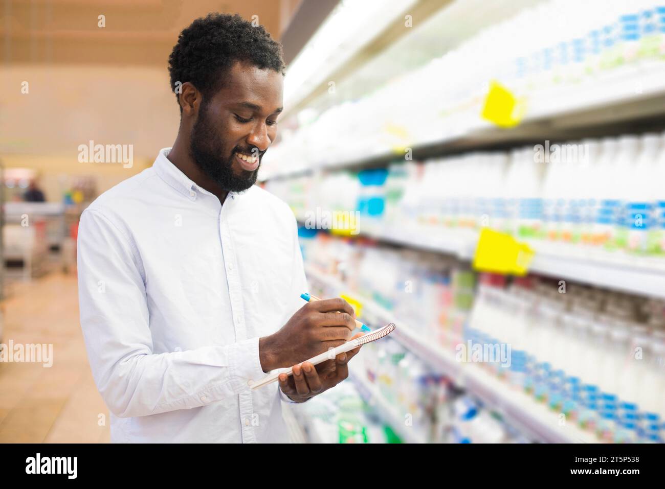 Male checking off items grocery list Stock Photo - Alamy