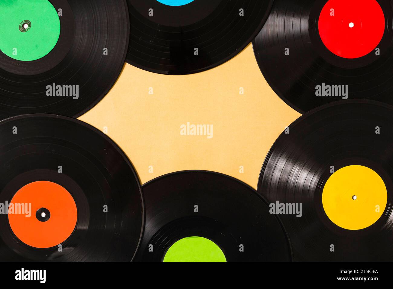 Overhead view colorful black vinyl record beige background Stock Photo ...