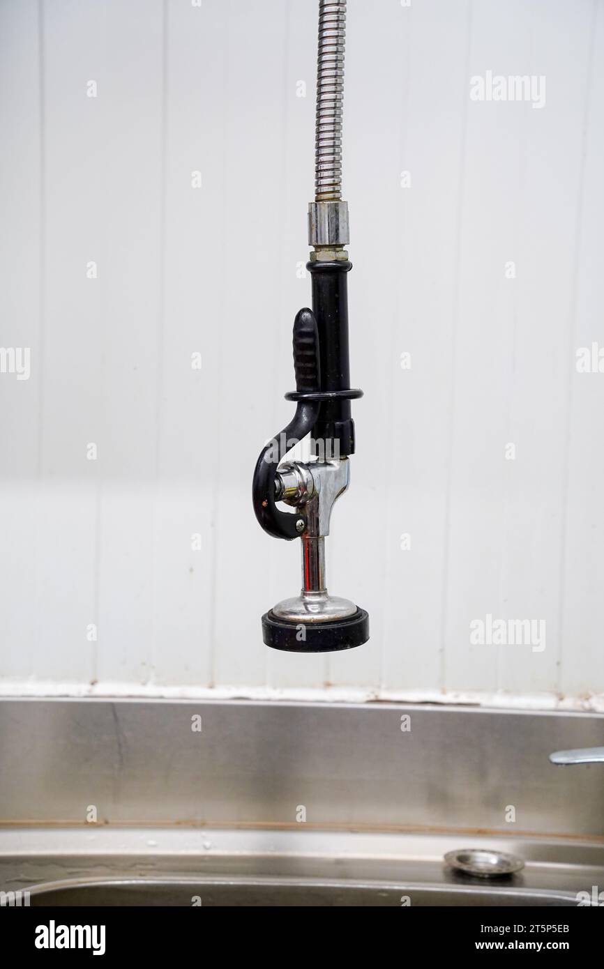 water faucet for washing up in an industrial kitchen. hanging water ...