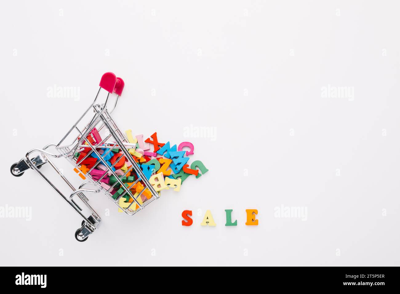 Overturned shopping cart filled with letters Stock Photo - Alamy