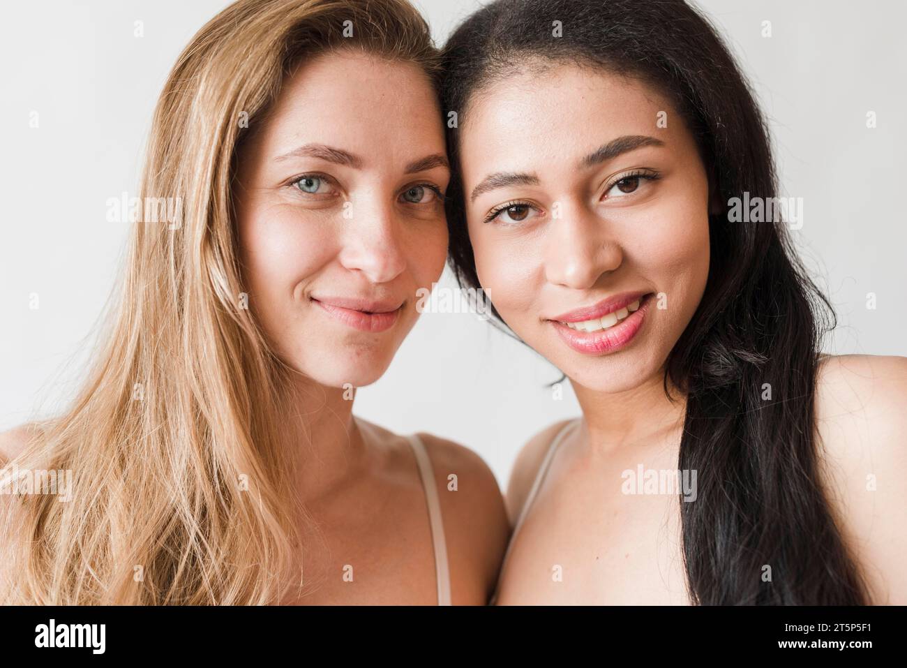 Multiracial beautiful women looking camera Stock Photo - Alamy